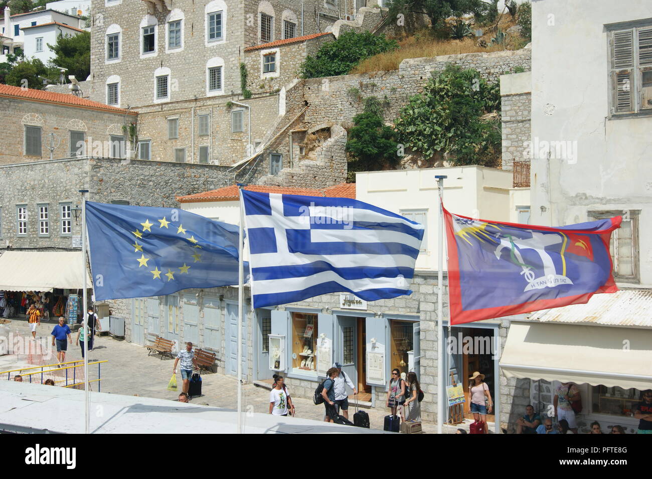 "Three flags side by side on the atmospheric traditional Greek island ...