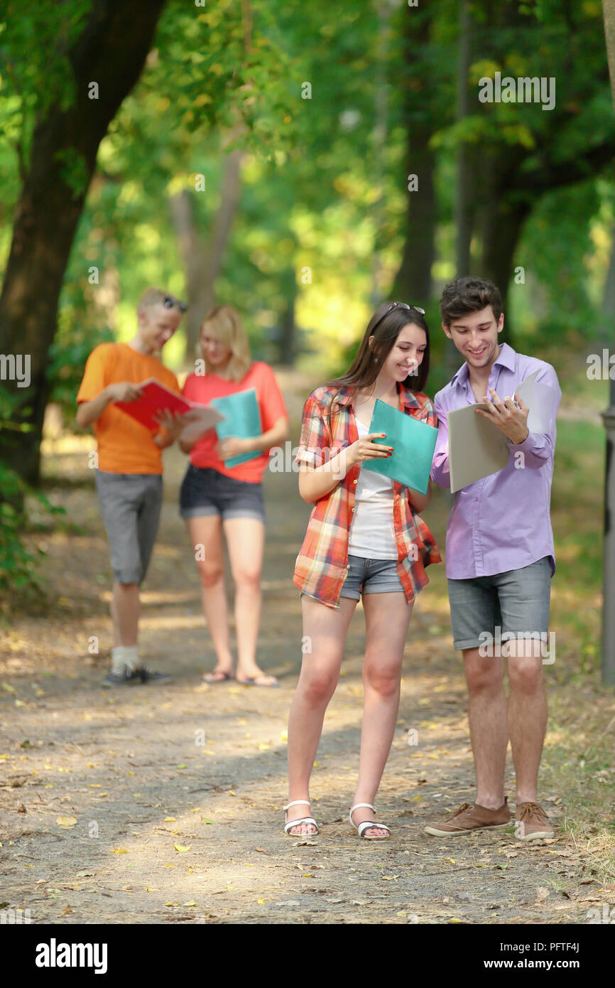 group of students discussing exam questions standing in the Park Stock ...