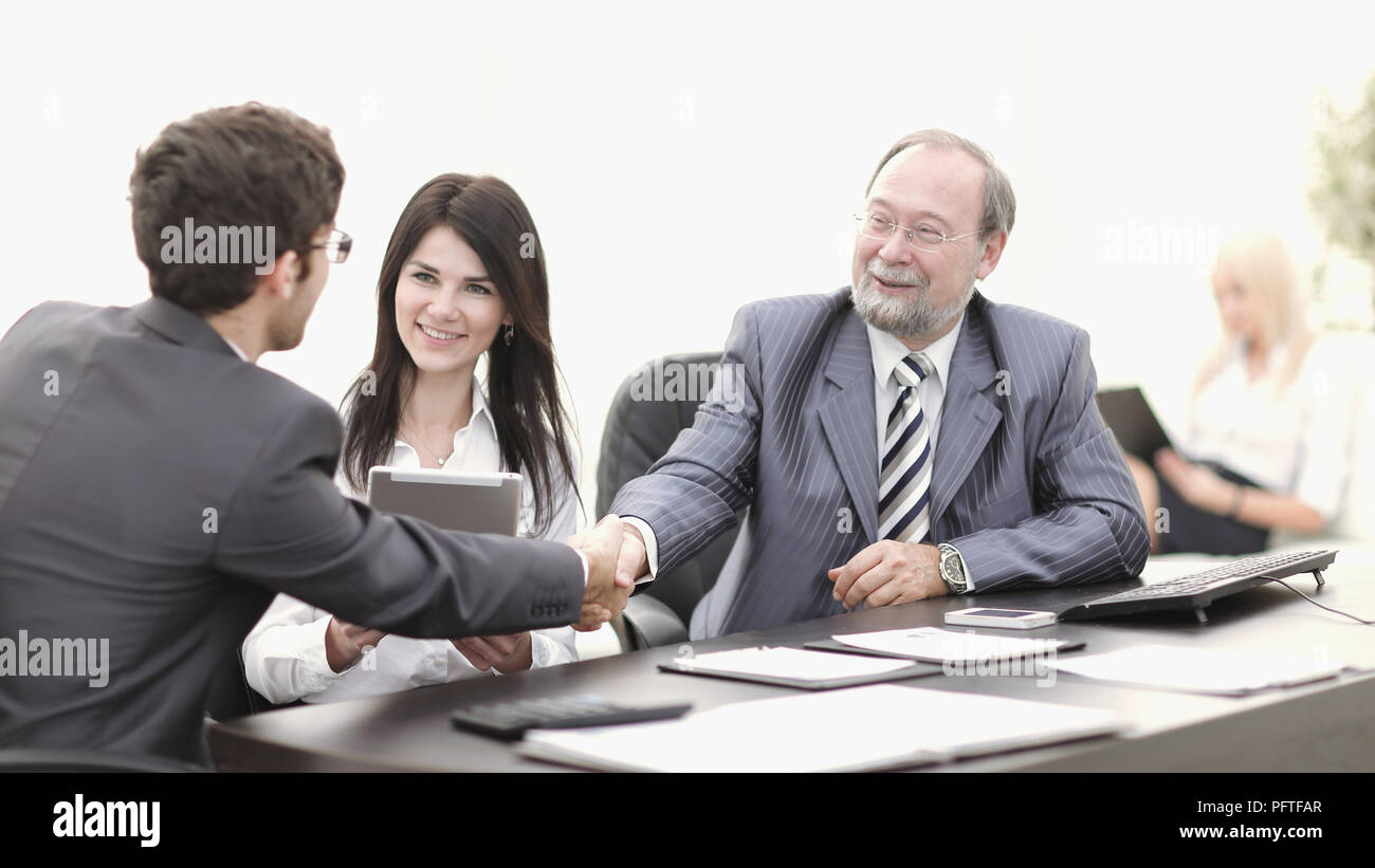 handshake between colleagues in the workplace in the office Stock Photo ...