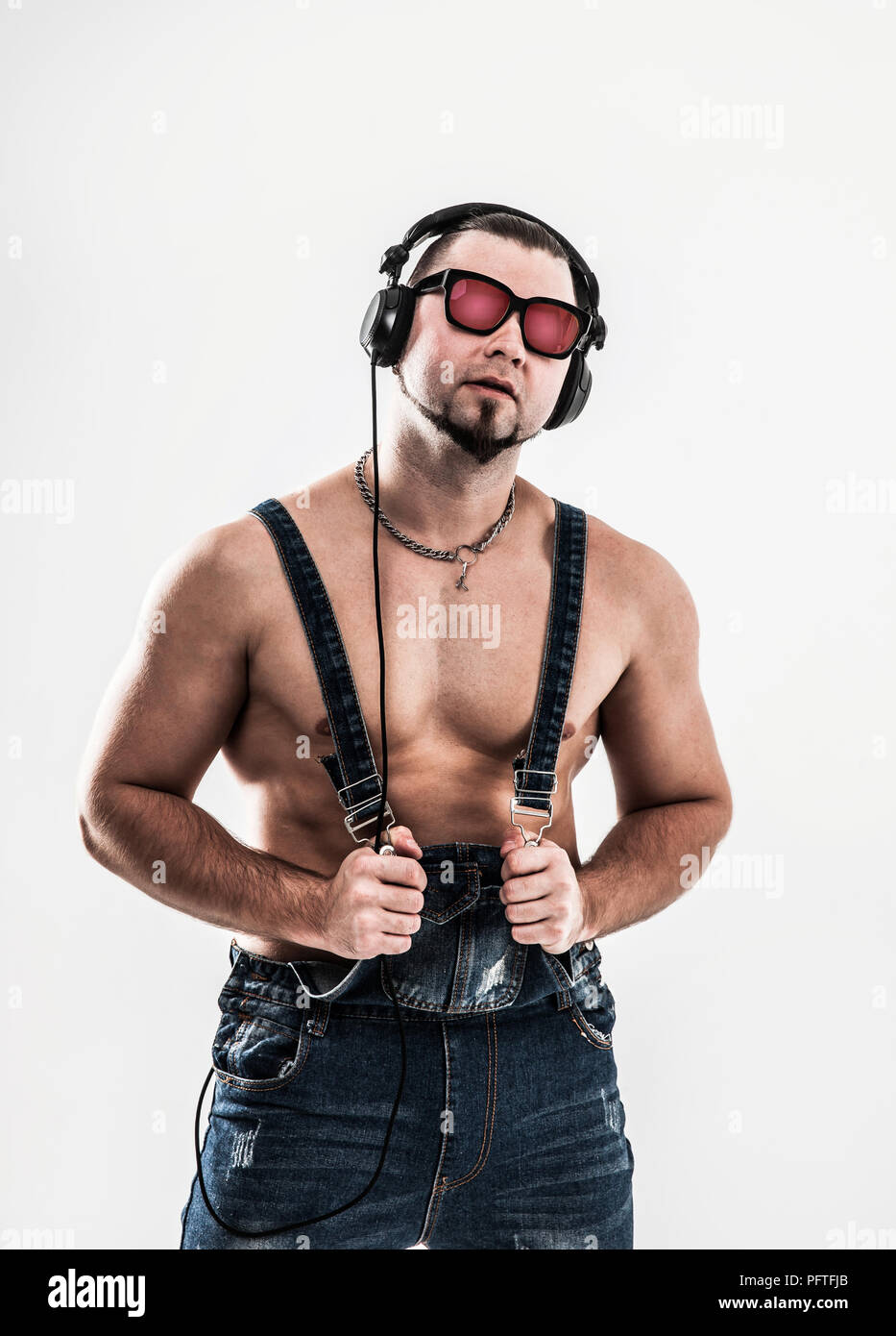 emotional and charismatic DJ - rapper with headphones on a light Stock ...