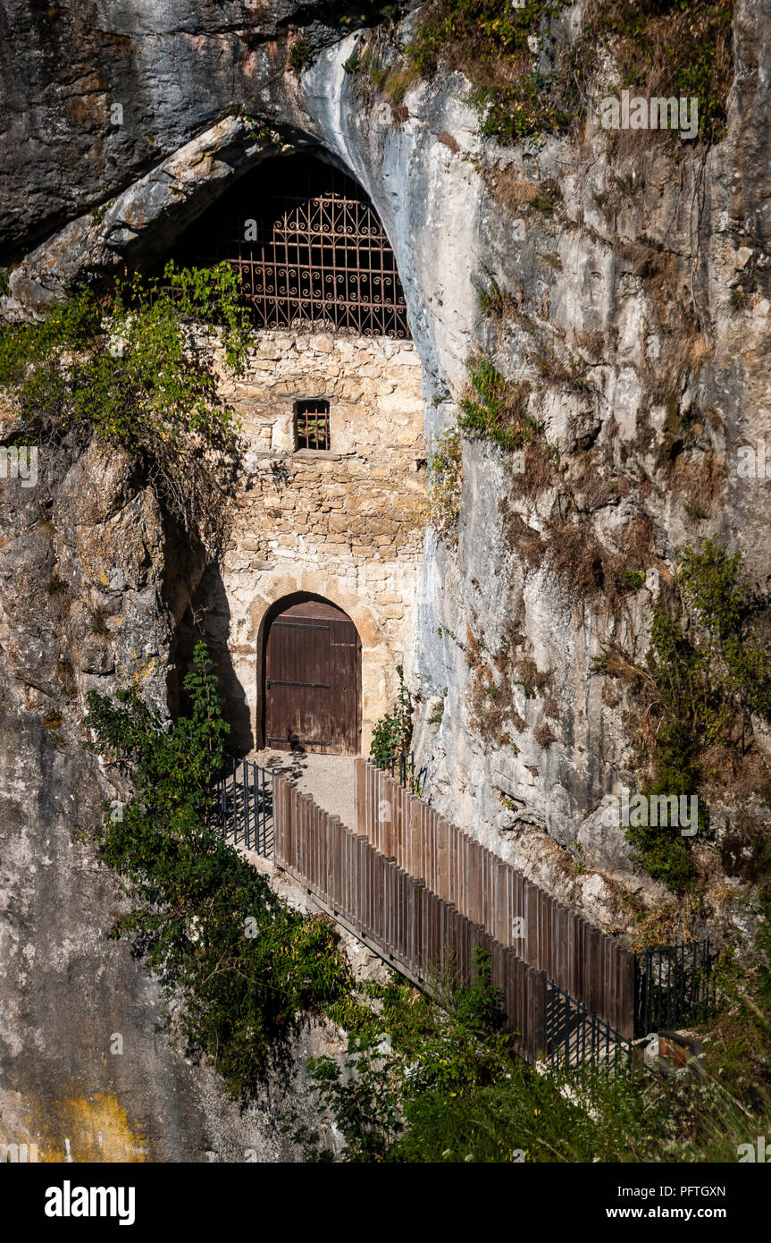 Cave below Predjama castle. Wooden prison door Stock Photo - Alamy