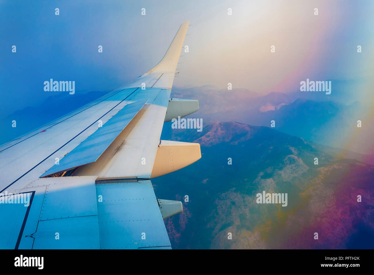 Mountain scenery from the air through the airplane window rainbow ...