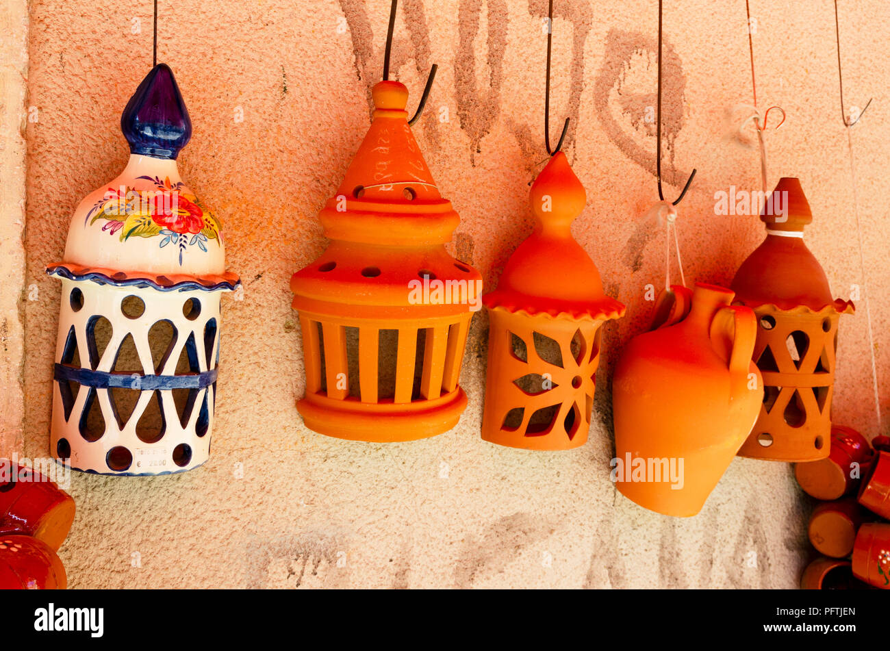 A selection of Greek wall lamps on show on shop wall, Symi, Greece ...