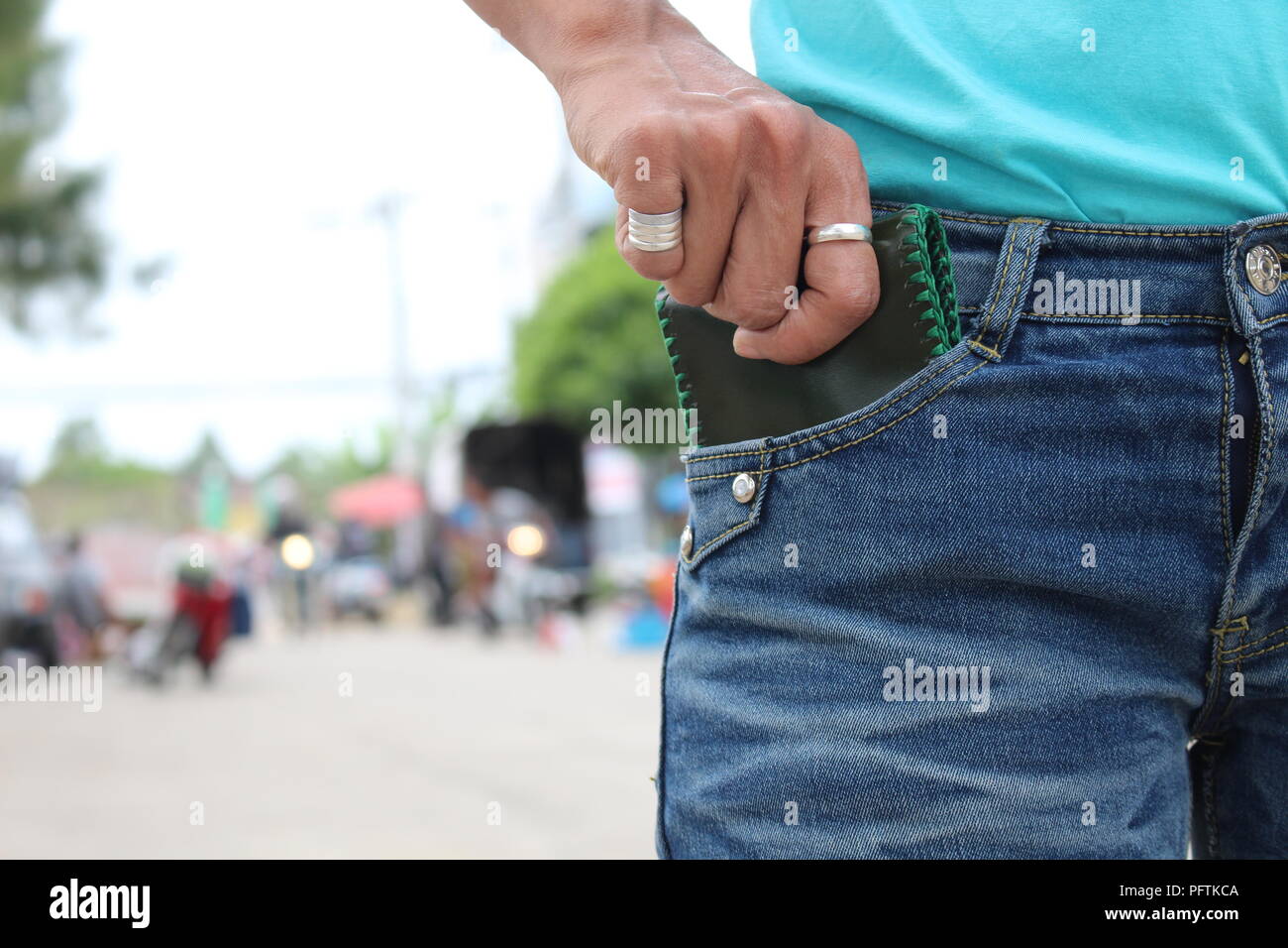 man picking wallet from jeans pocket Stock Photo - Alamy