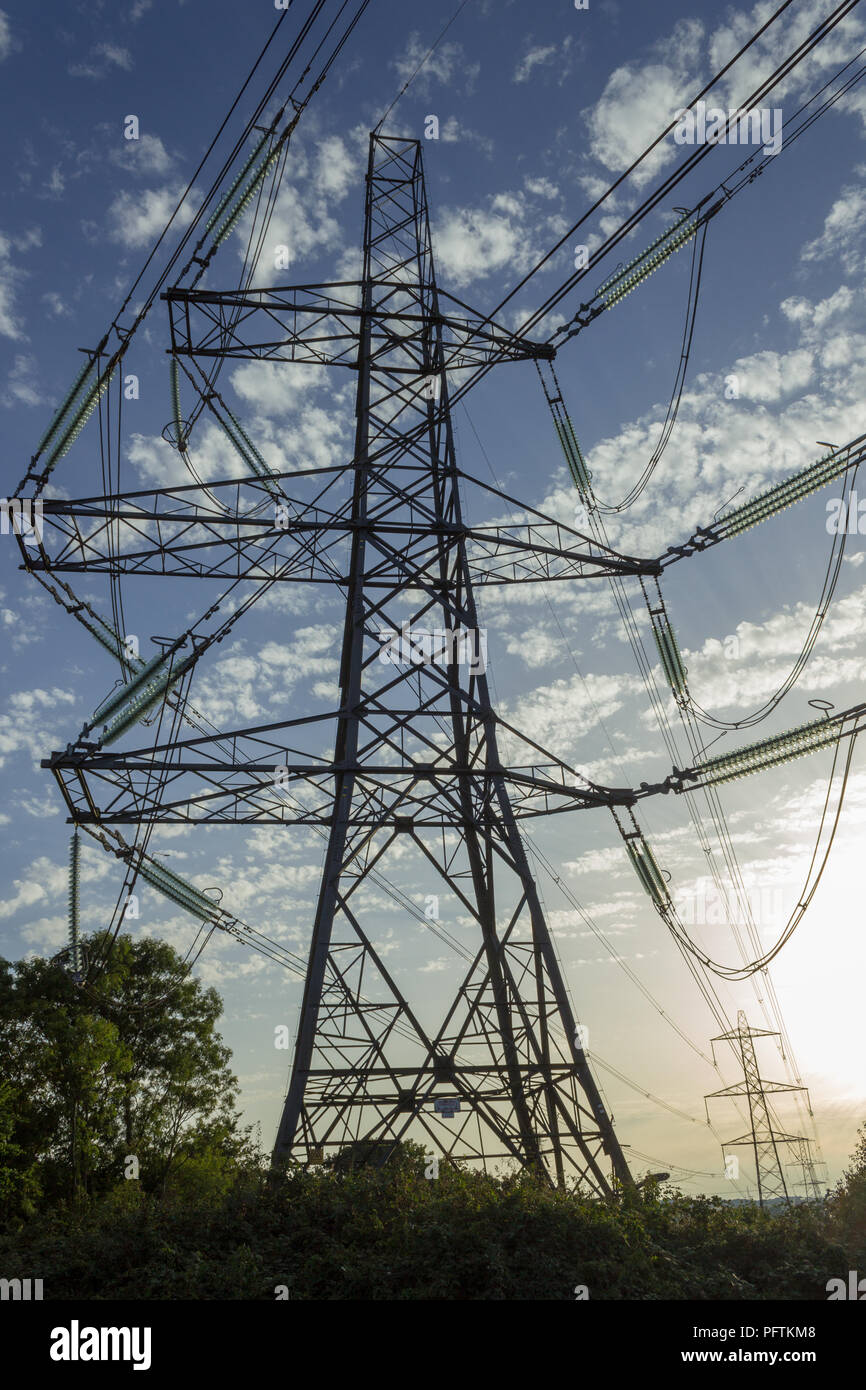 Electricity pylon against low sunlight Stock Photo - Alamy