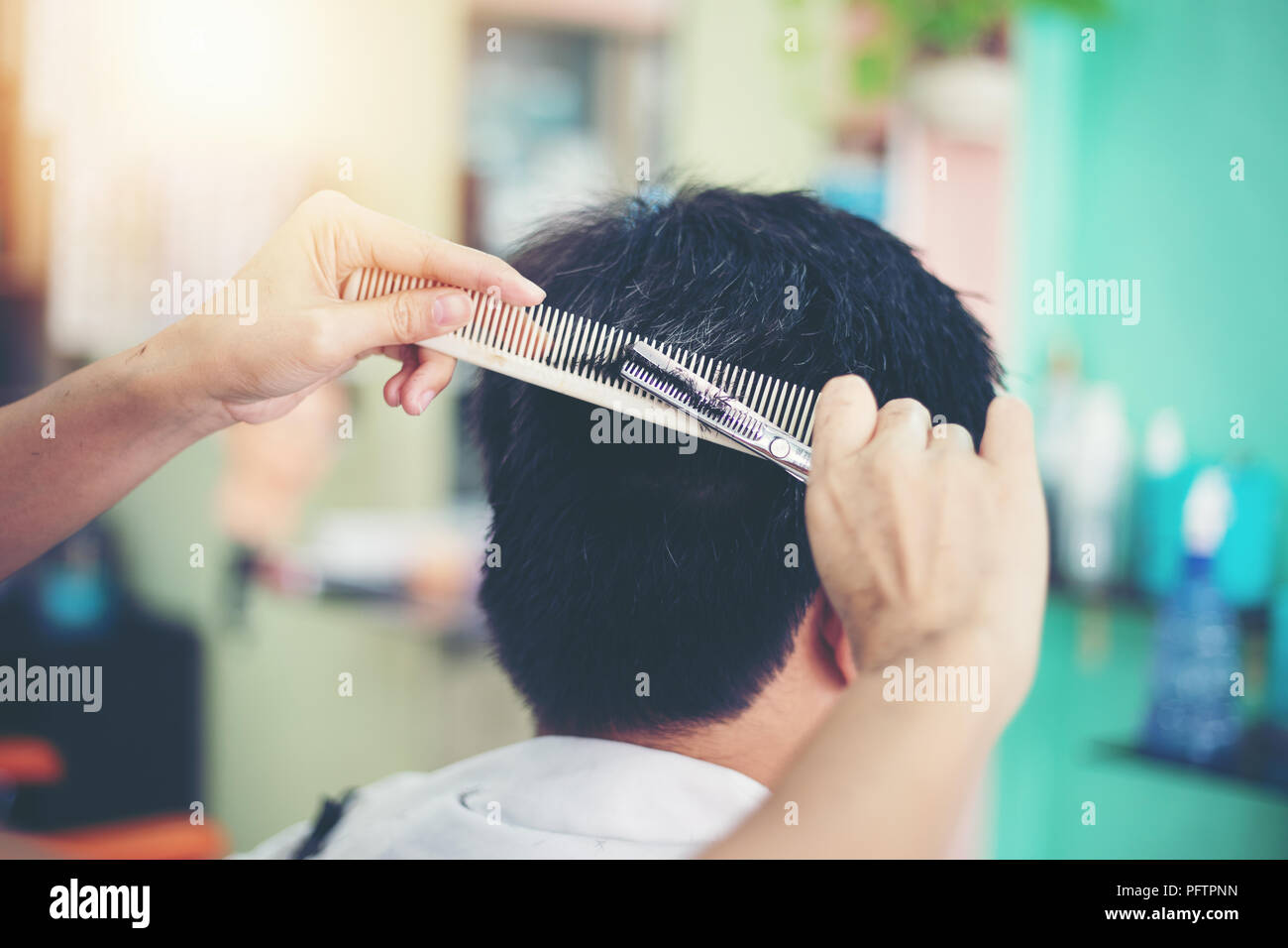 a man cutting hair at barber Stock Photo - Alamy