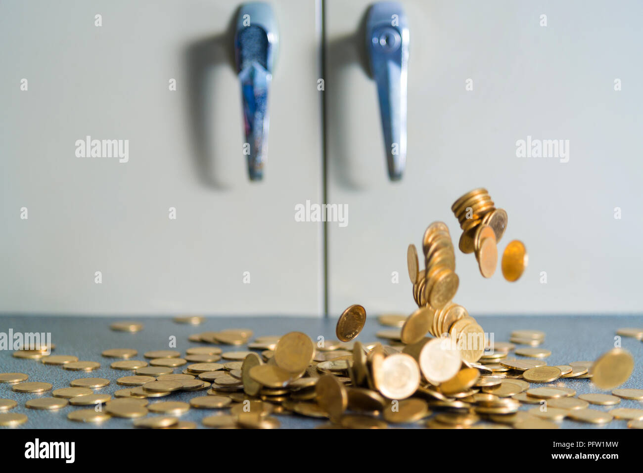 Falling gold coins money on office table with document cabinet ...