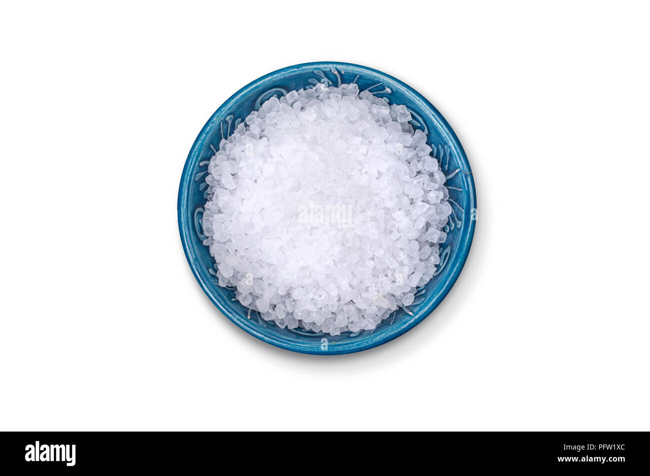 Natural sea iodized salt in a small blue traditional bowl isolated on a ...