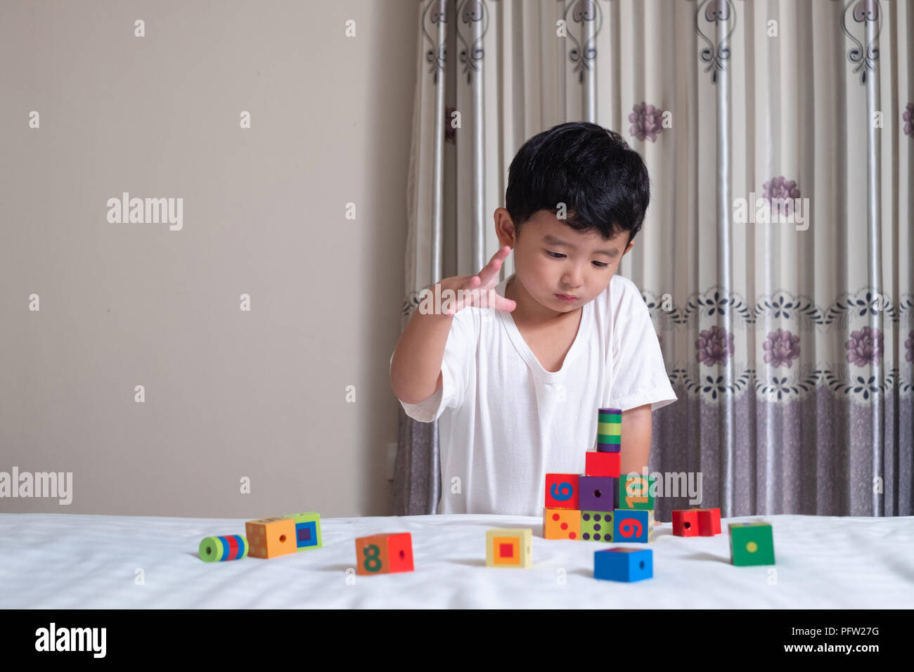3 years old little cute Asian boy play toy or square block puzzle at ...