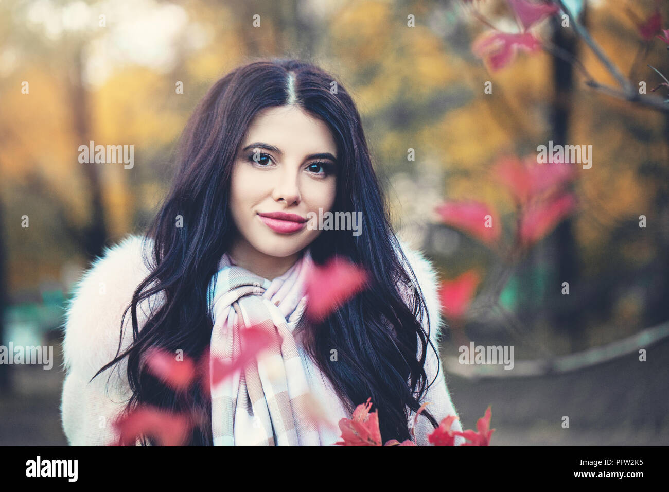 Autumn woman with long dark hair outdoor in fall park Stock Photo - Alamy