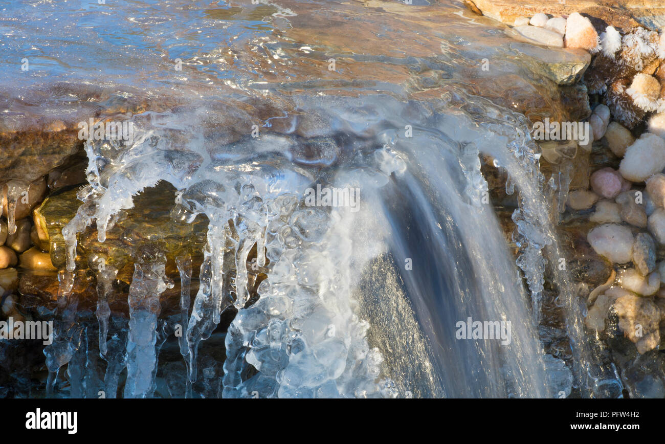 Water on a small waterfall still running through the ice Stock Photo ...