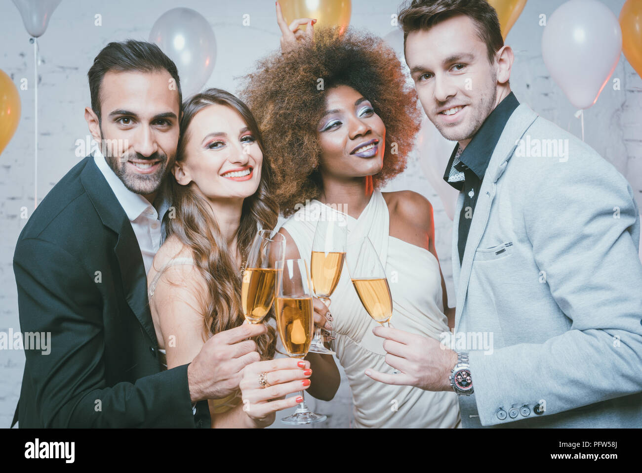 Group of party people celebrating with drinks Stock Photo - Alamy