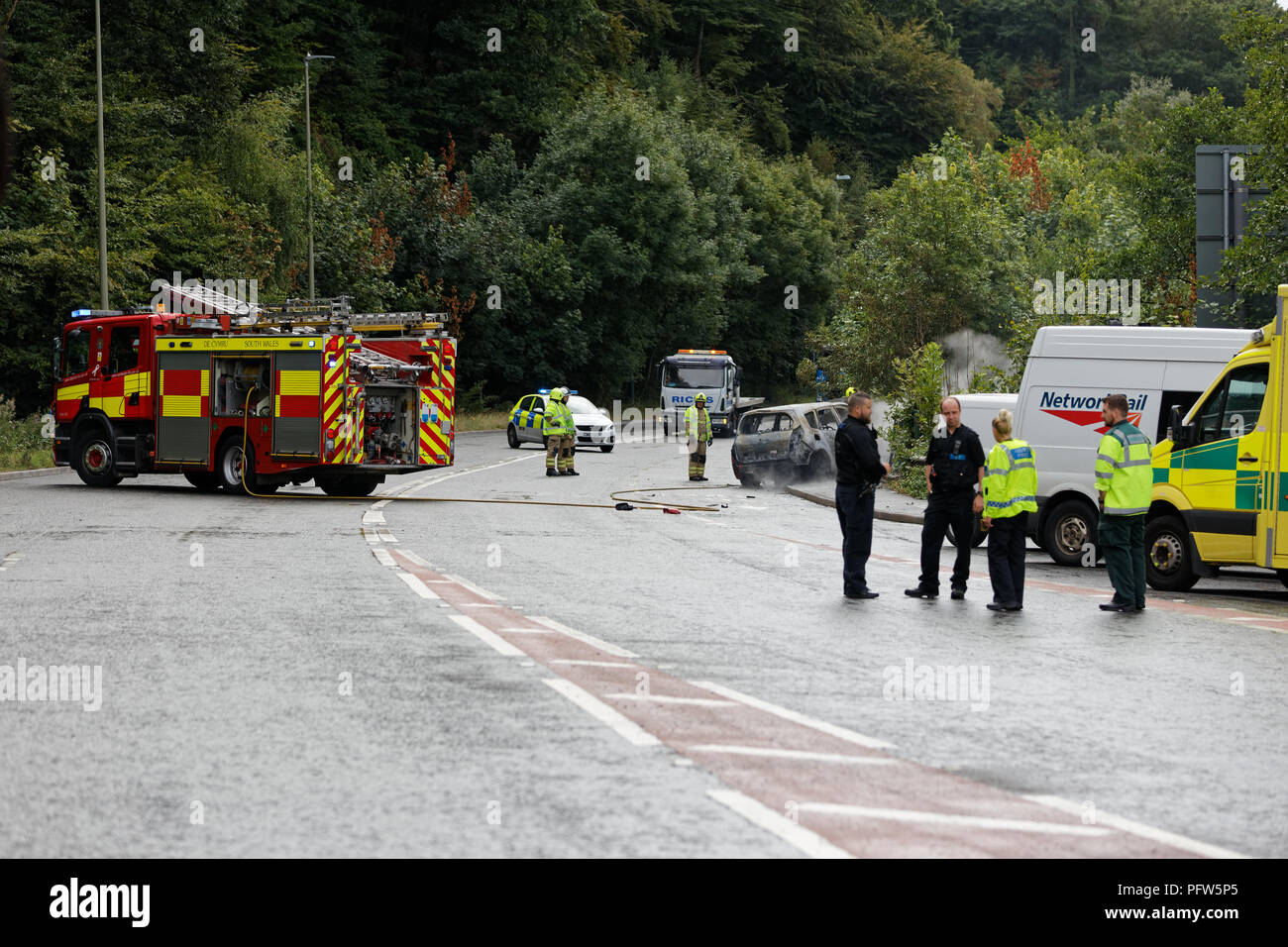 Fire service personnel and police officers attend the scene of a fire ...