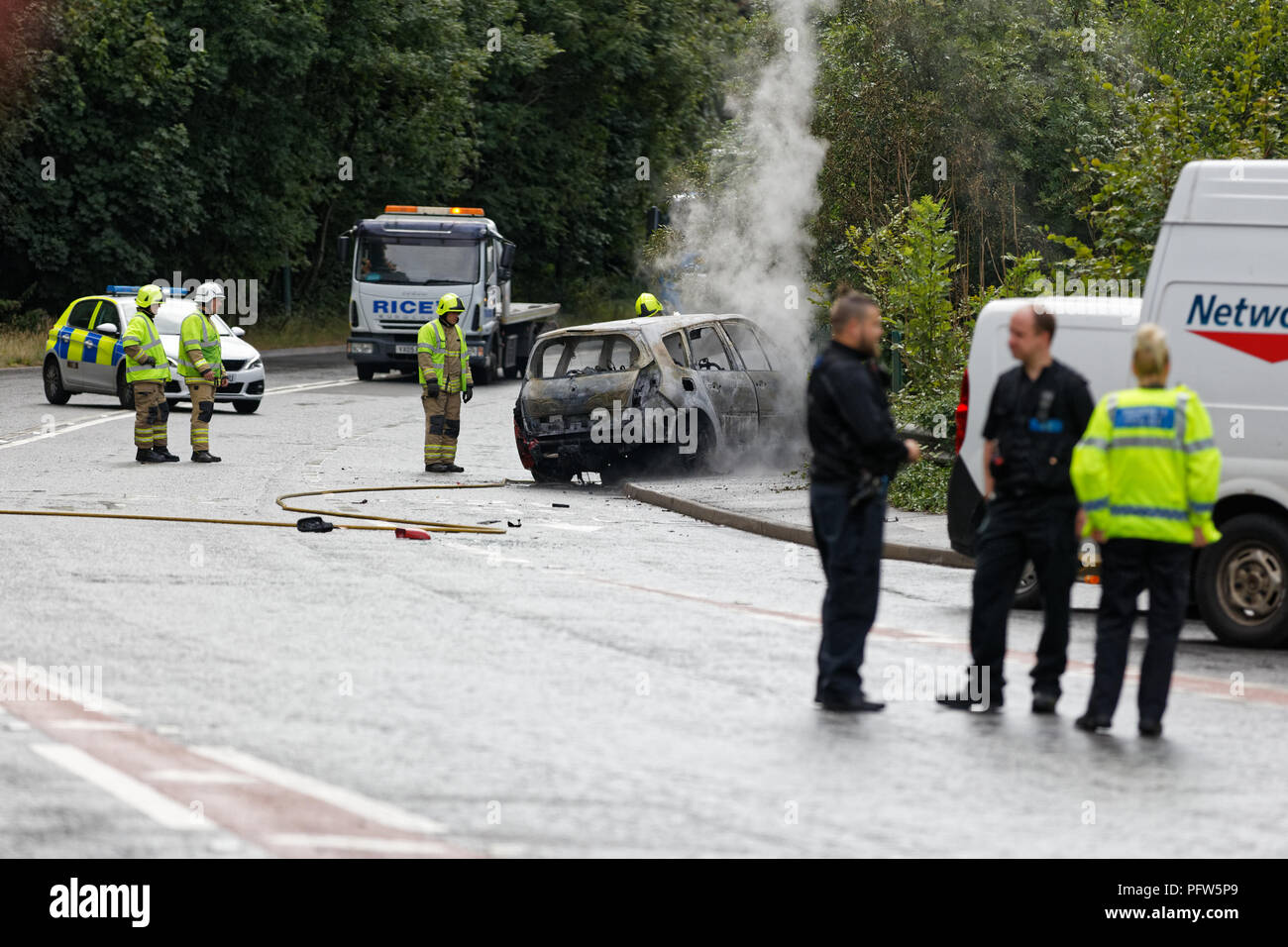 Fire service personnel and police officers attend the scene of a fire ...