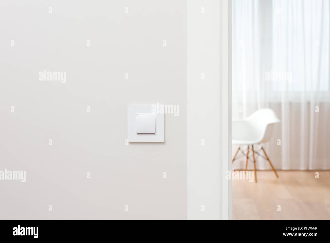 The wall switch is in the bright, contemporary interior. Open the door ...