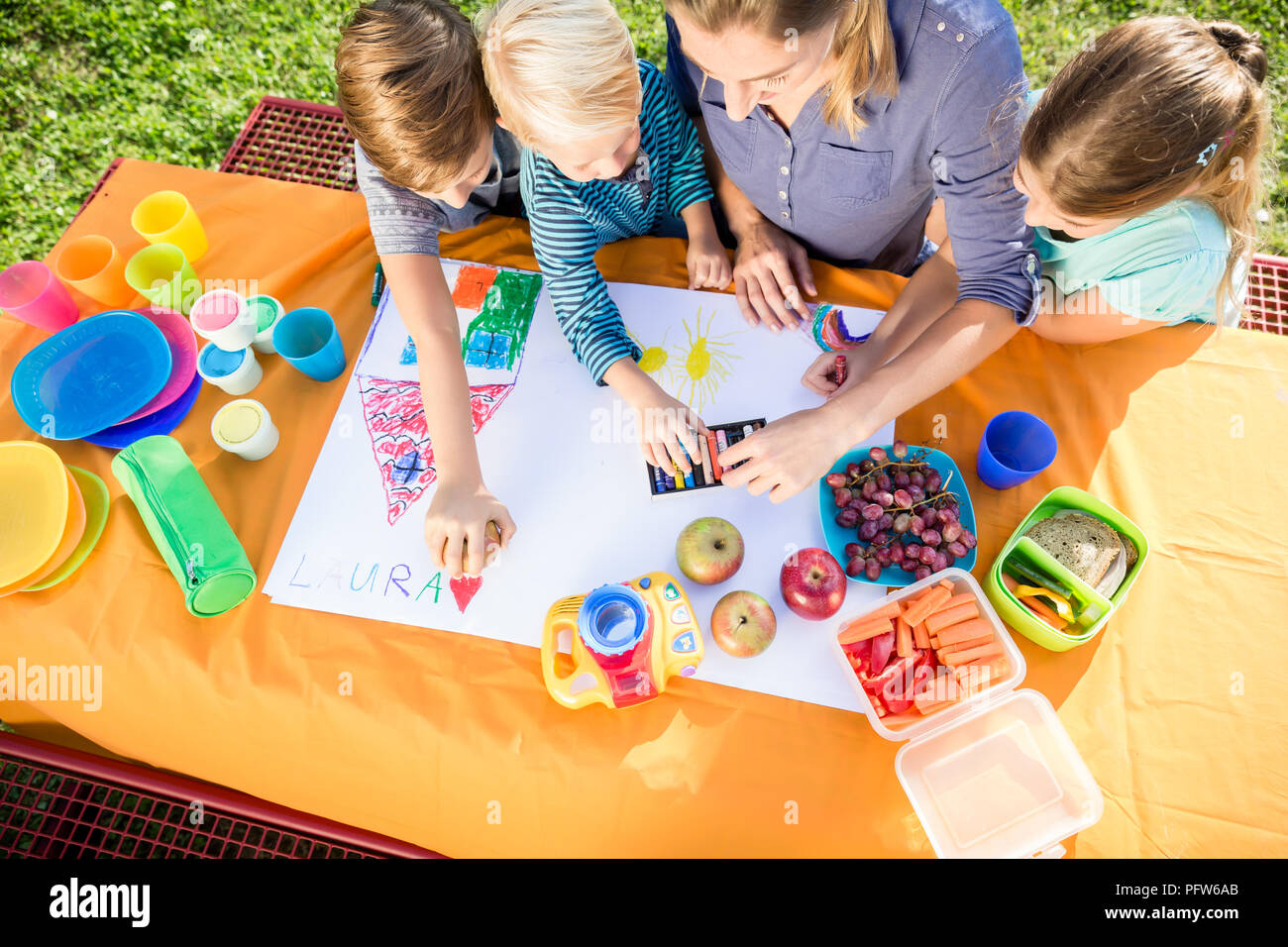 Schoolgirls and schoolboys painting during lunch break Stock Photo - Alamy