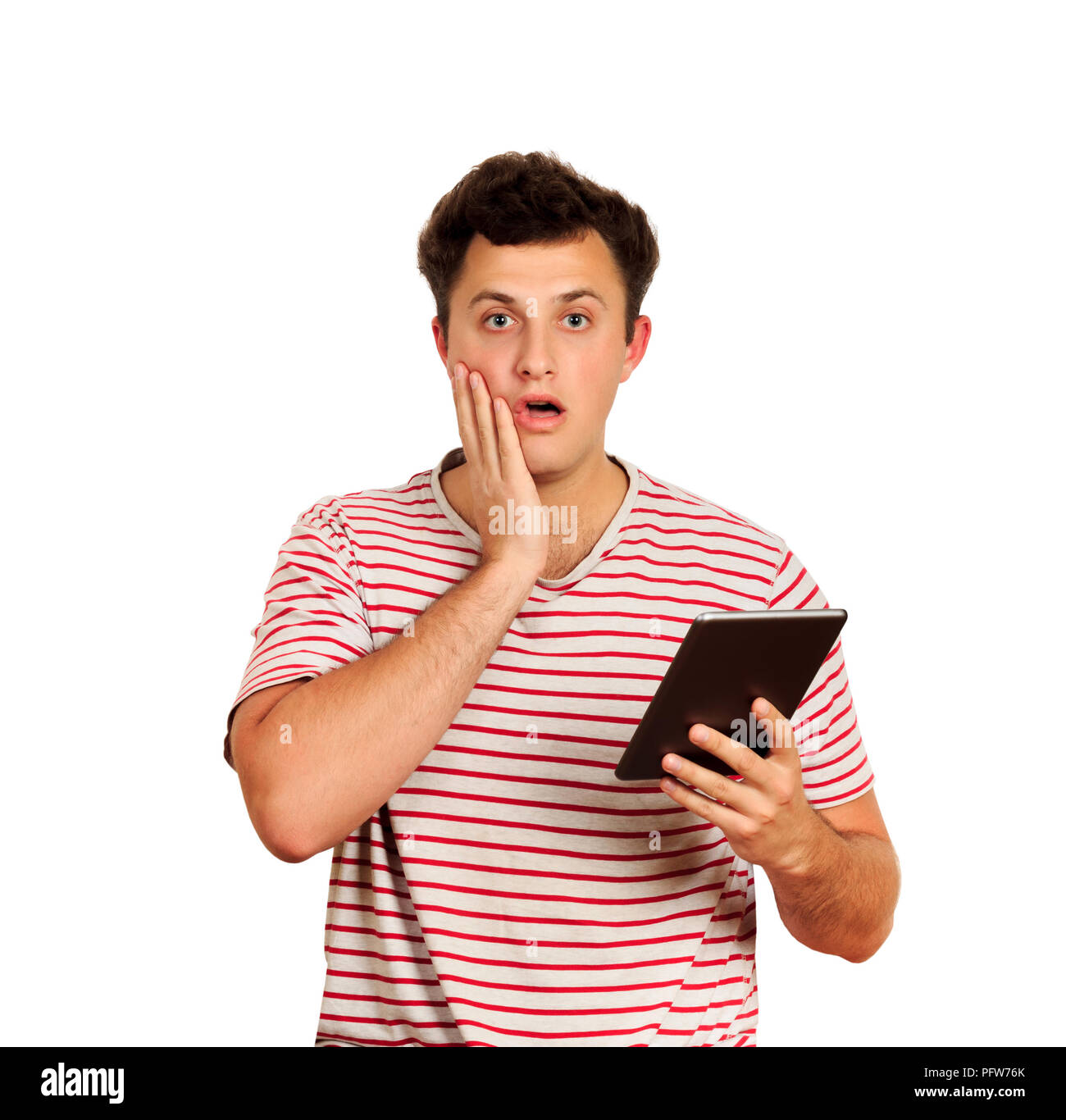 shocked guy looking at camera and holding a tablet computer. emotional ...