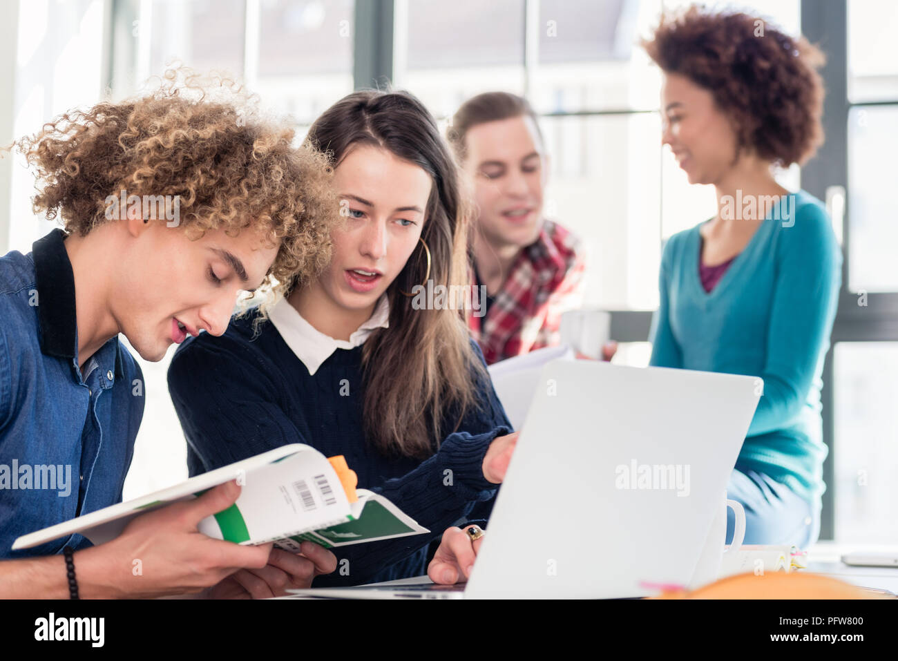 Two young students searching for an answer to their question Stock ...