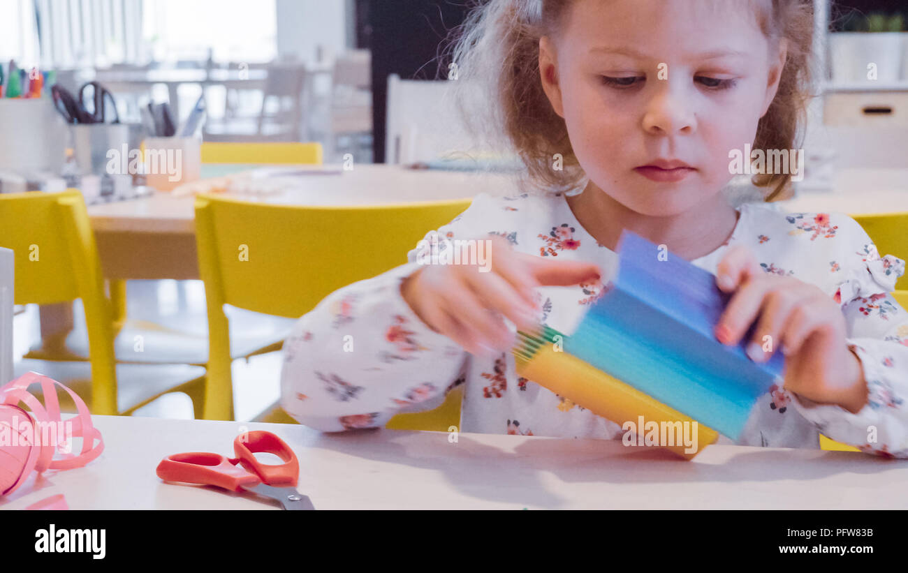 Little girl making paper butterflies from multicolor paper Stock Photo ...