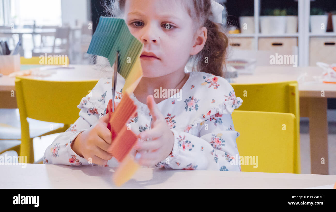 Little girl making paper butterflies from multicolor paper Stock Photo ...