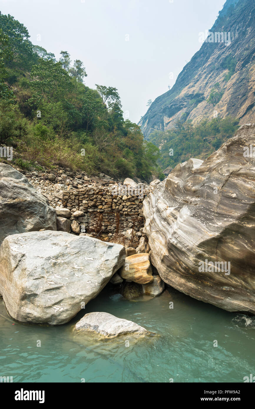 Huge rocks on a mountain river in the Himalayas in the spring day ...