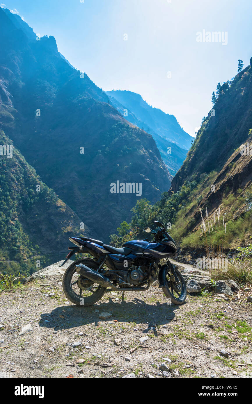 Motorcycle in contour light on the background of mountain gorge ...