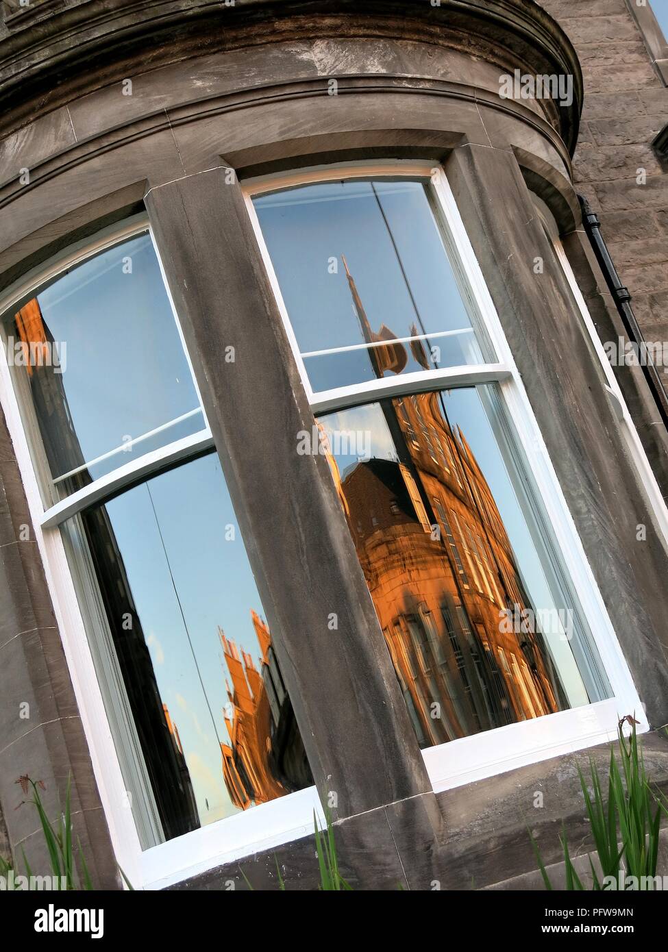 Reflection of buildings on curved house window Stock Photo - Alamy