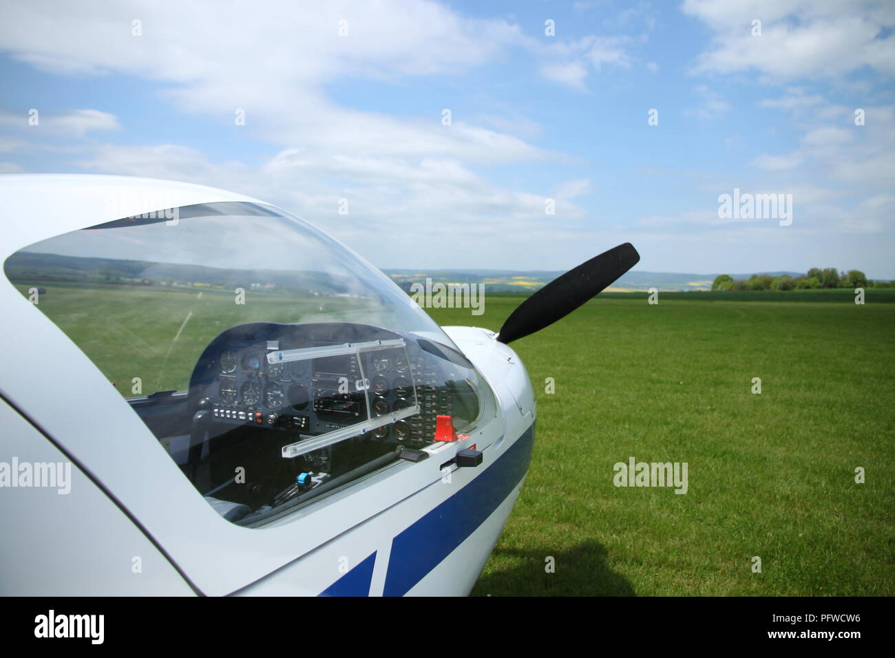 White small propeller airplane on field perspective Stock Photo - Alamy
