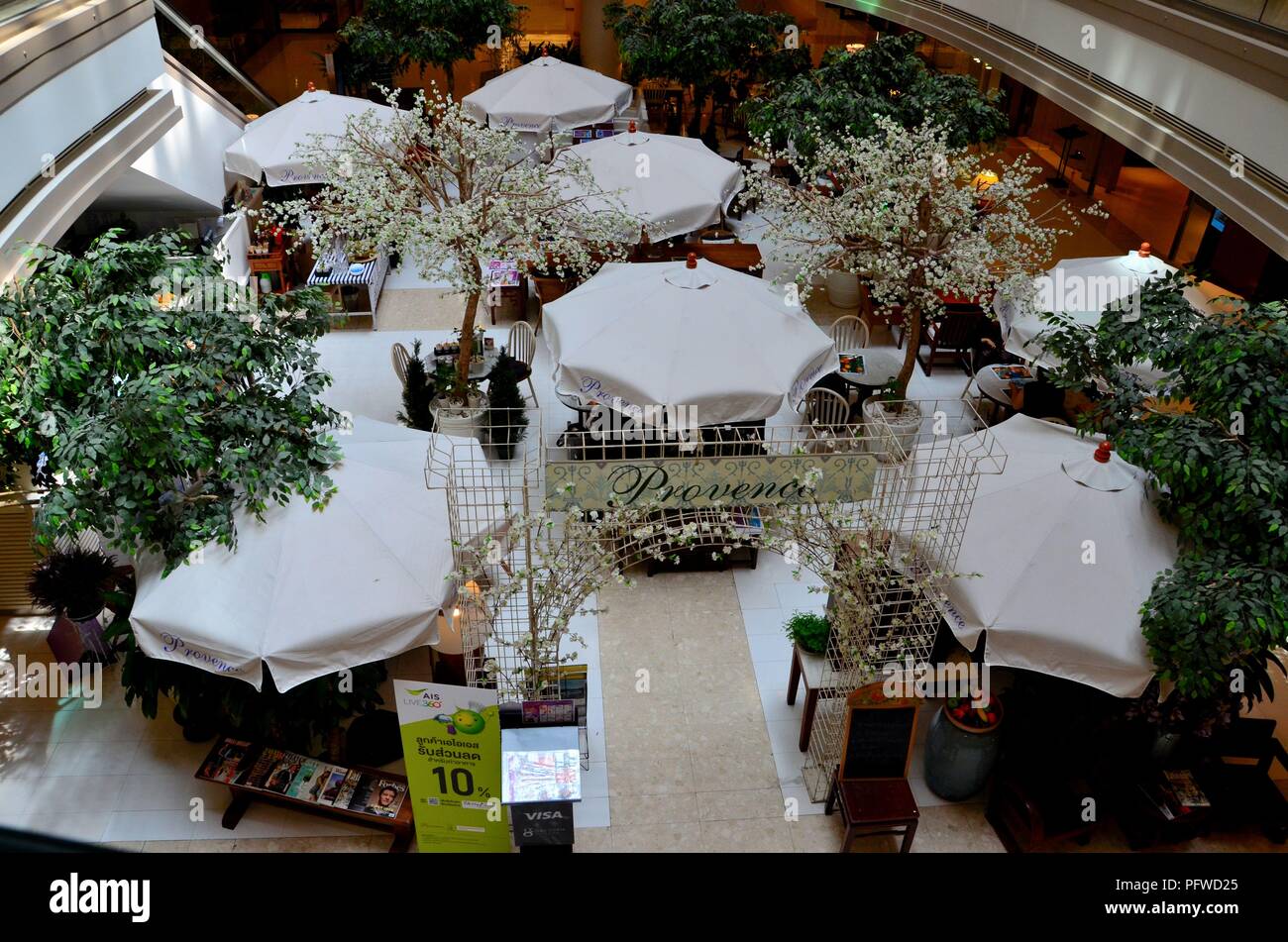 Seating arrangement with umbrellas for upscale French cafe restaurant ...