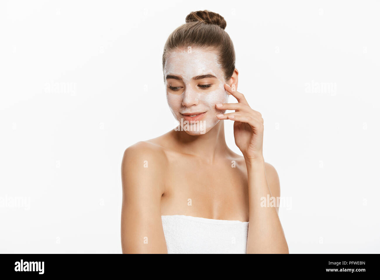 Beautiful woman with facial white mask on white background Stock Photo ...