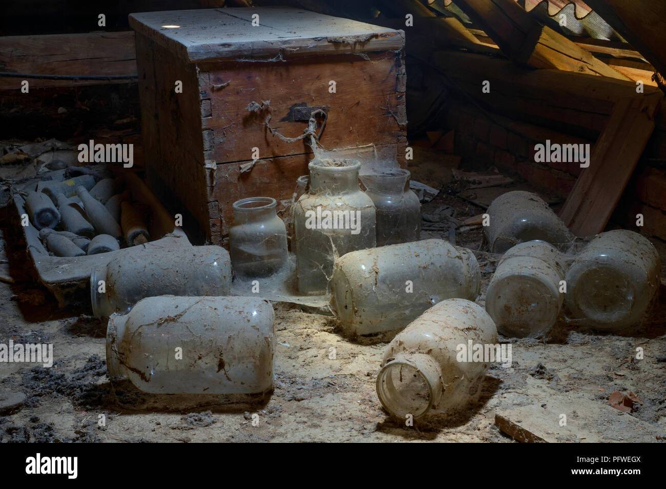 old glass jars and wooden box covered in dust and cobwebs laying ...