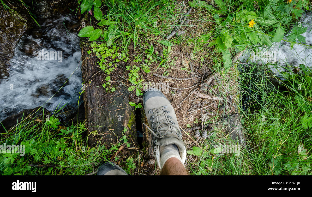 Walking shoe on a wooden small bridge over a quick floating river Stock ...