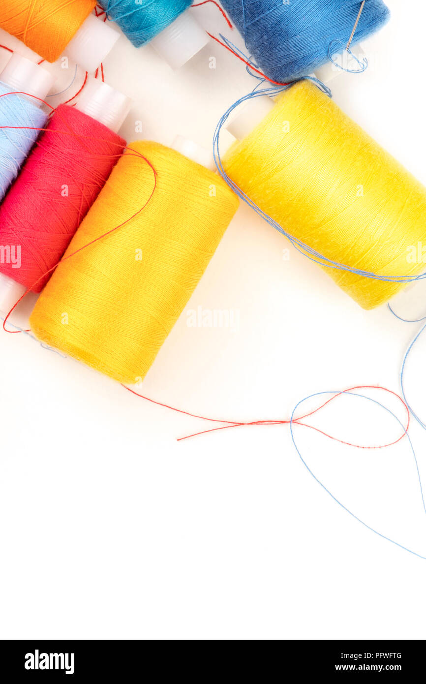 Overhead photo of threads of various colors on white with a place for ...