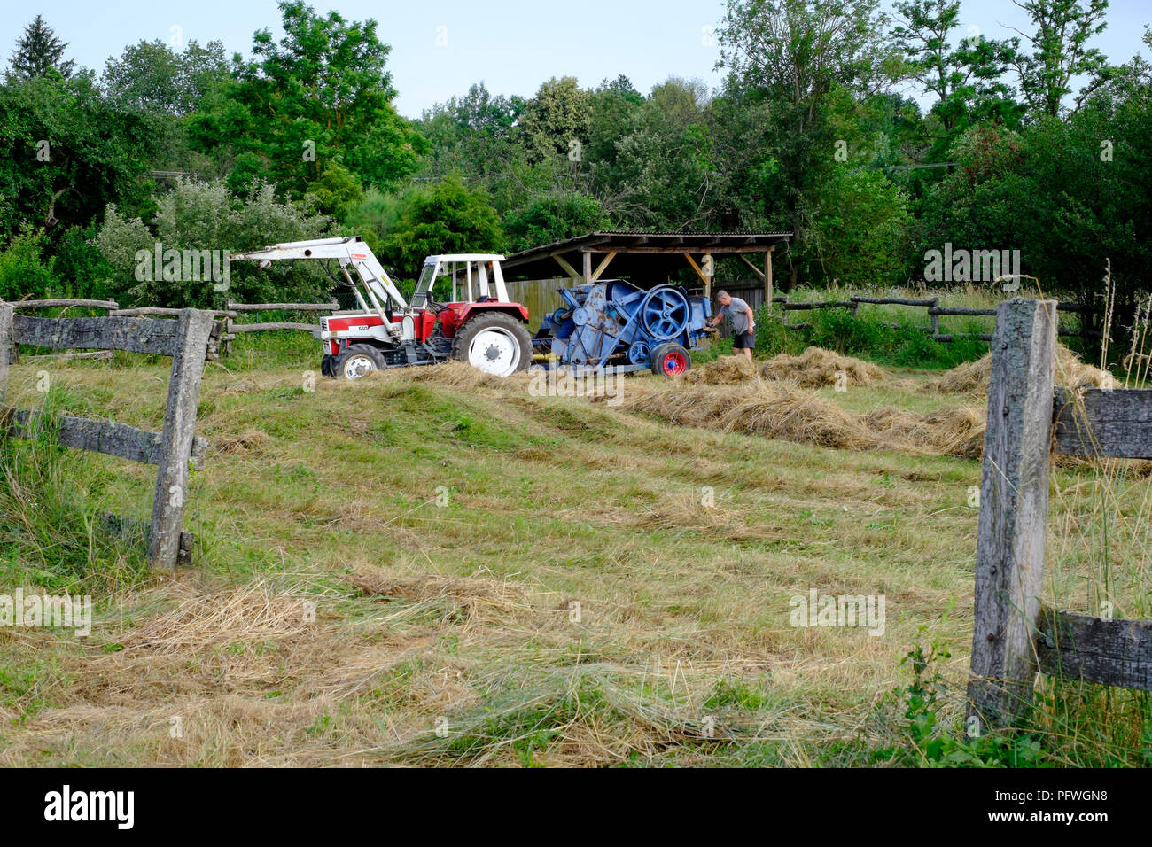 man using steyr 650 tractor and refurbished old baling machine to ...
