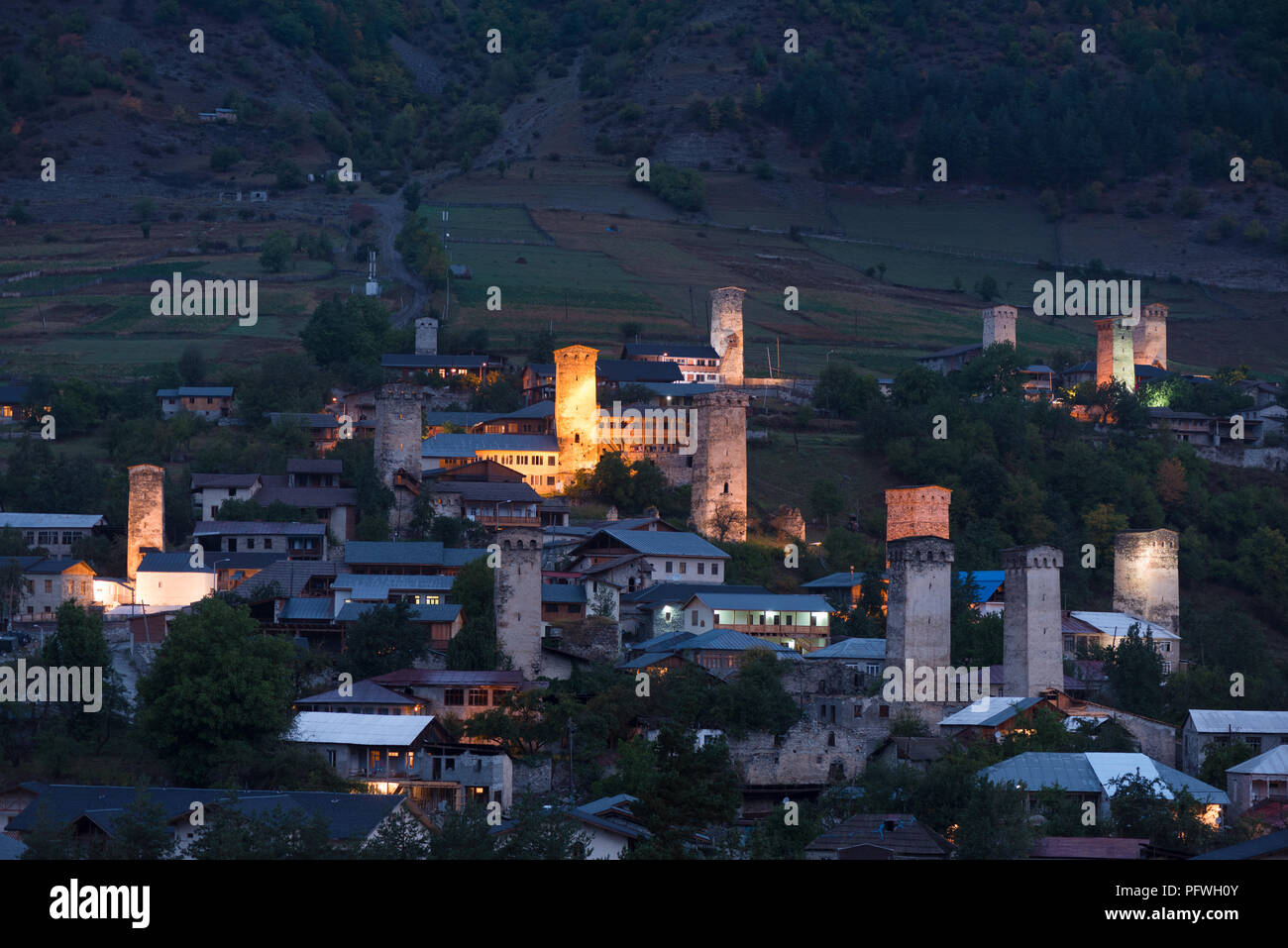 Night view of the city of Mestia. Medieval towers with illumination ...