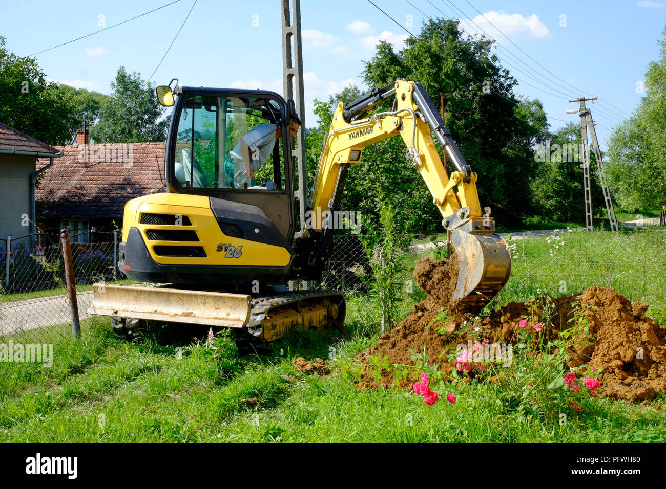 man using a mechanical digger in a garden to dig a trench zala county ...