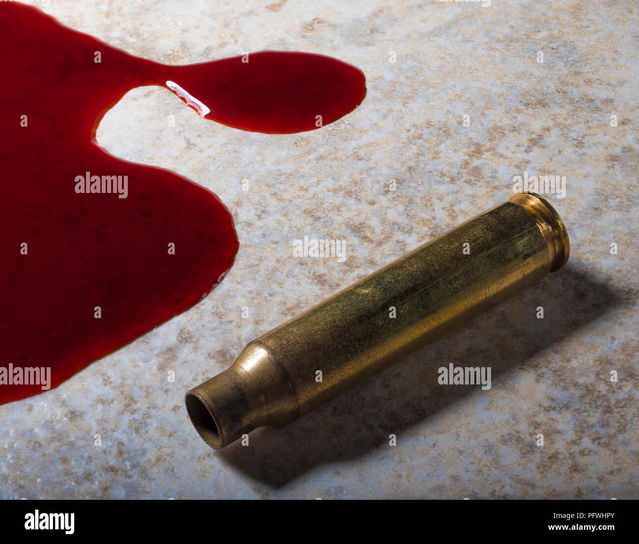 Blood on the floor with a single assault rifle casing Stock Photo - Alamy