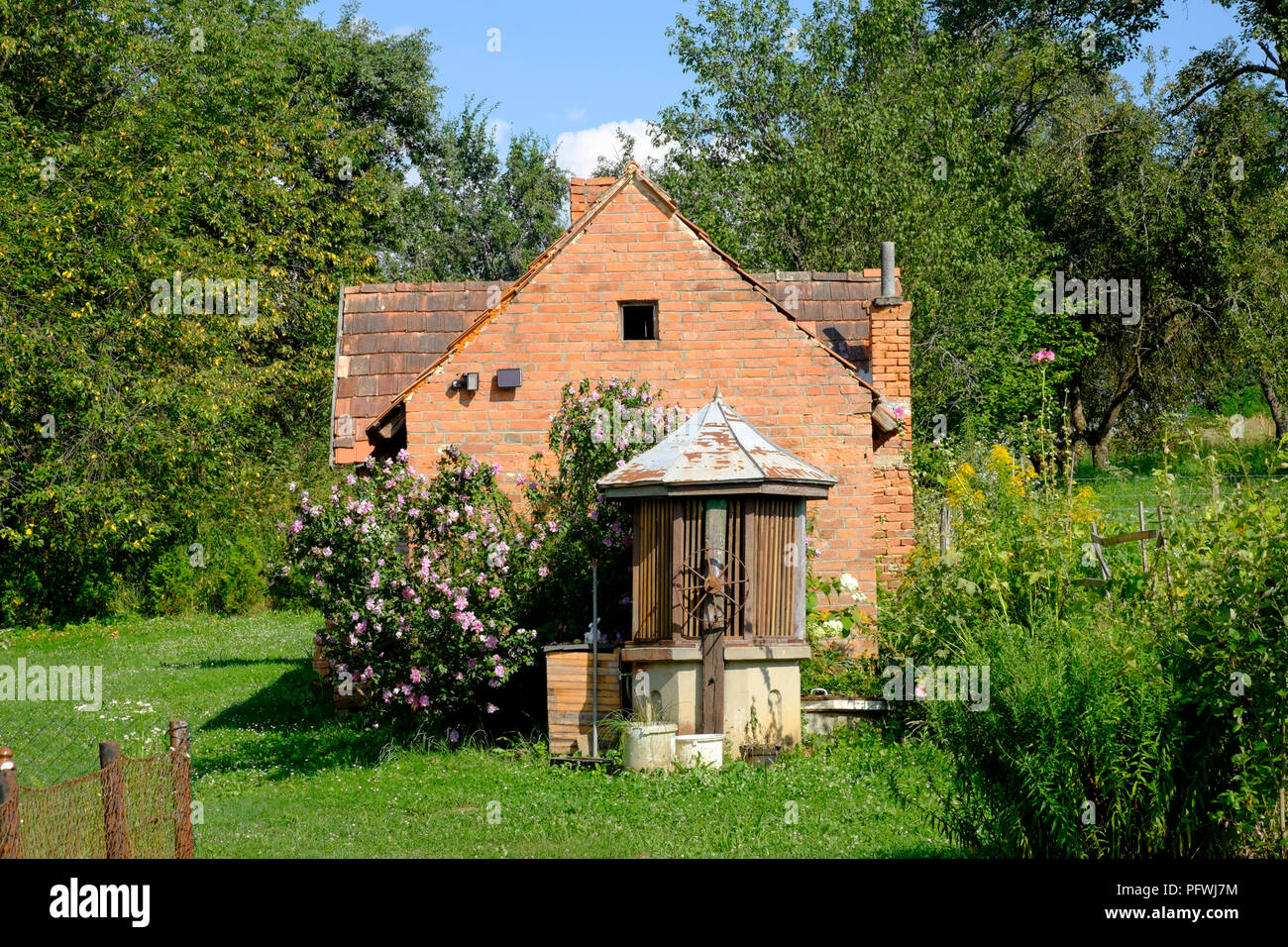 water well in front of summer kitchen outhouse in rural village house ...