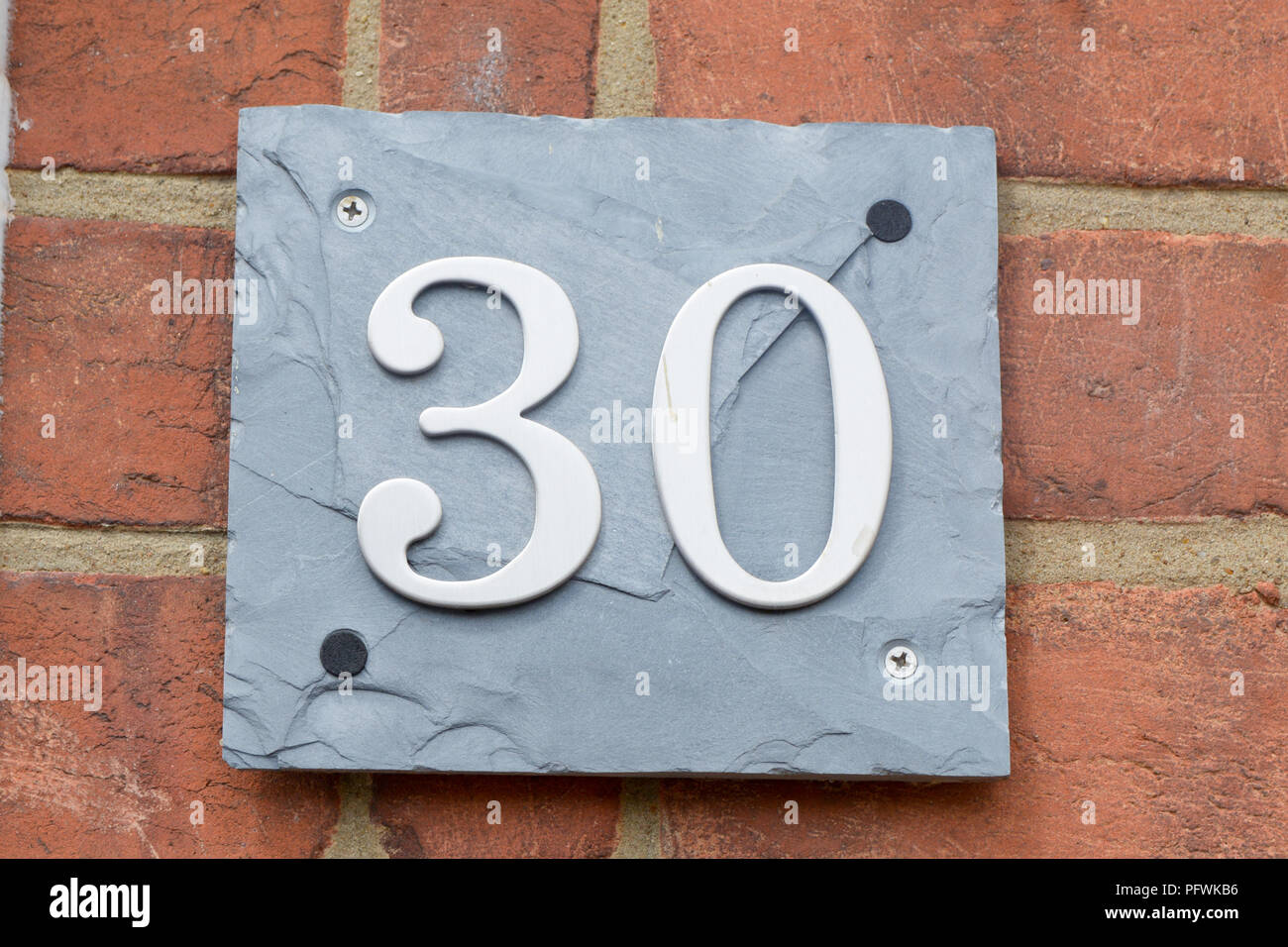 House number 30 sign - metal on slate Stock Photo - Alamy