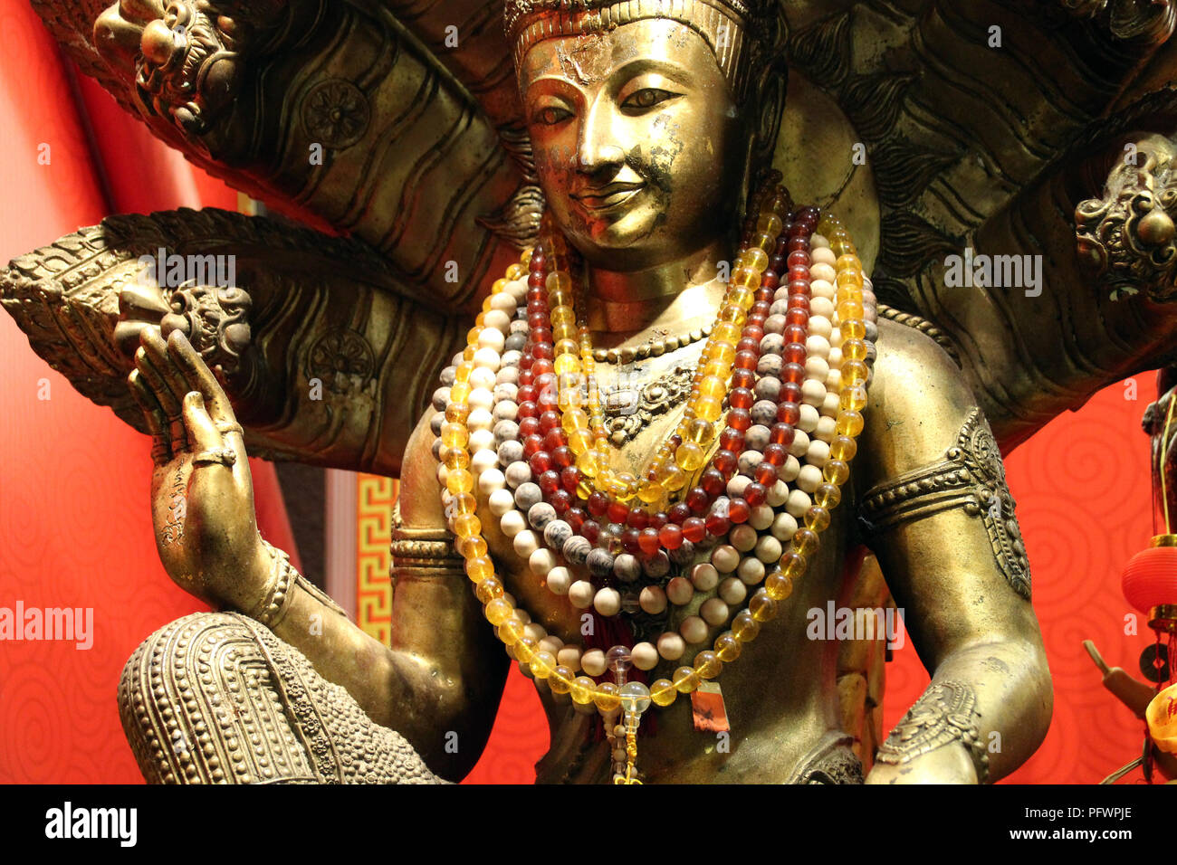 Statue of a divinity (Buddha ?) in Singapore Stock Photo - Alamy