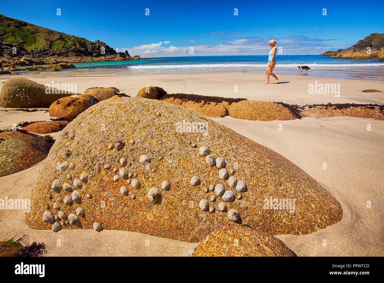 Weathered granite boulders on the beach at Porthmeor Cove, on Cornwall ...