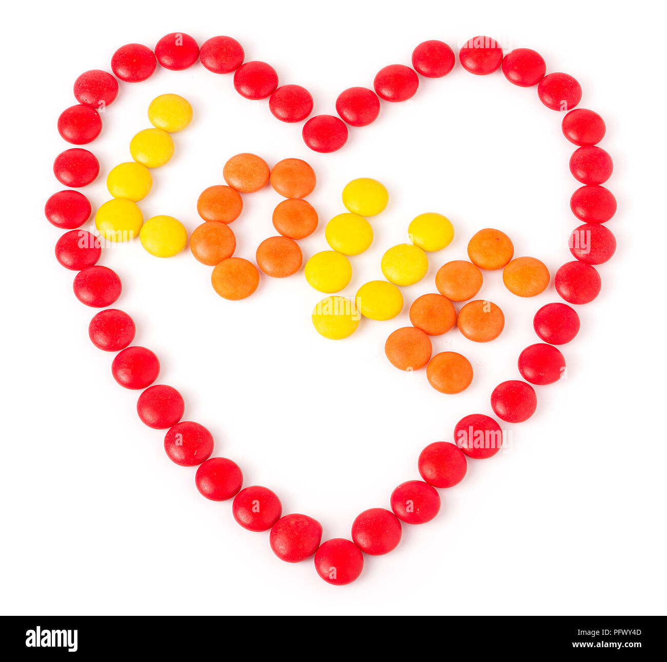 Heart made of red colored sweets round Stock Photo - Alamy