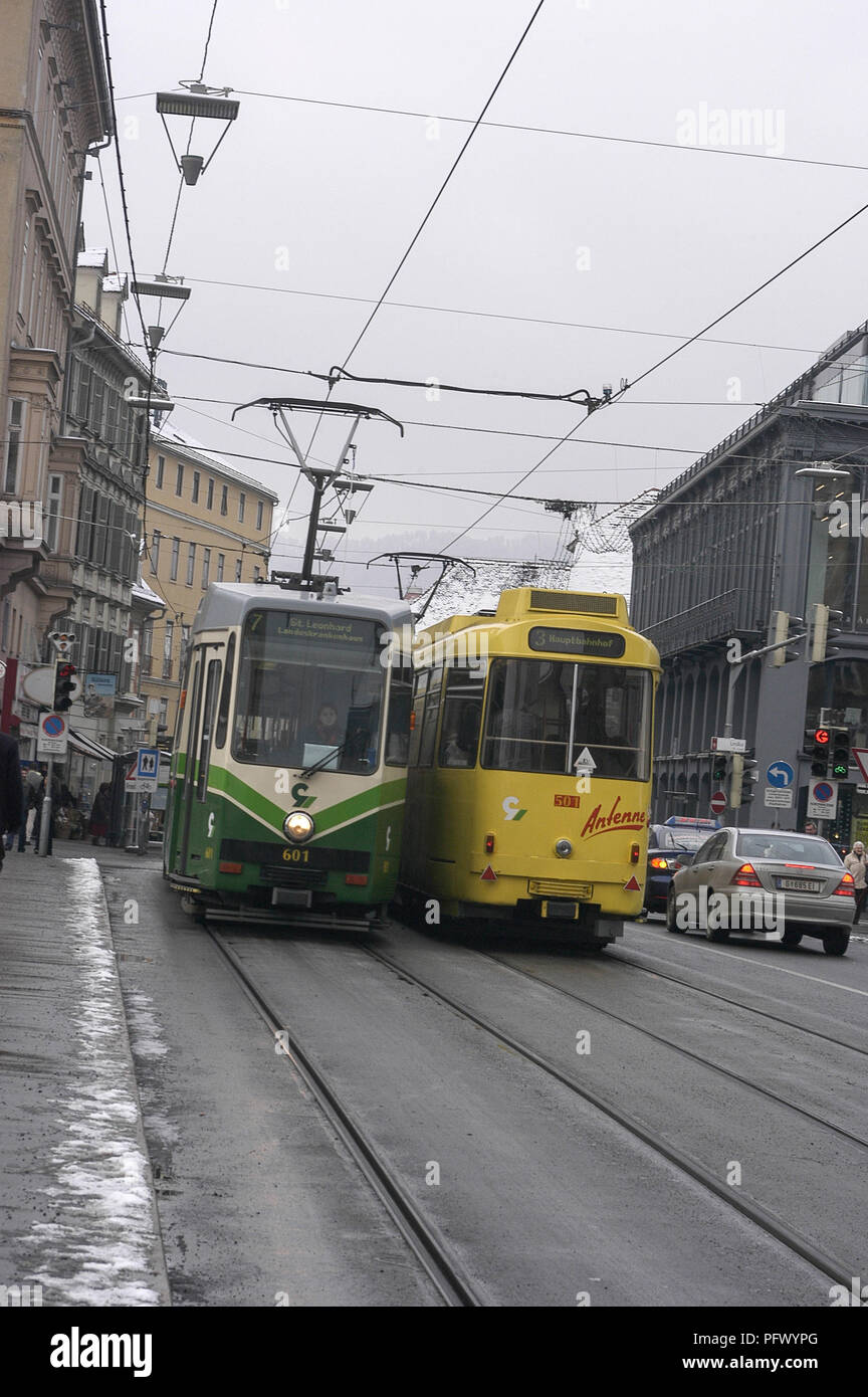 Two trams travelling in each direction n the streets of Graz in Austria ...