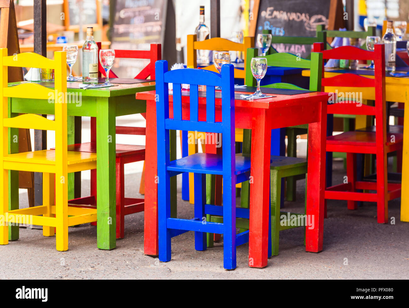 View of multi-colored chairs in a cafe on a city street, Buenos Aires ...