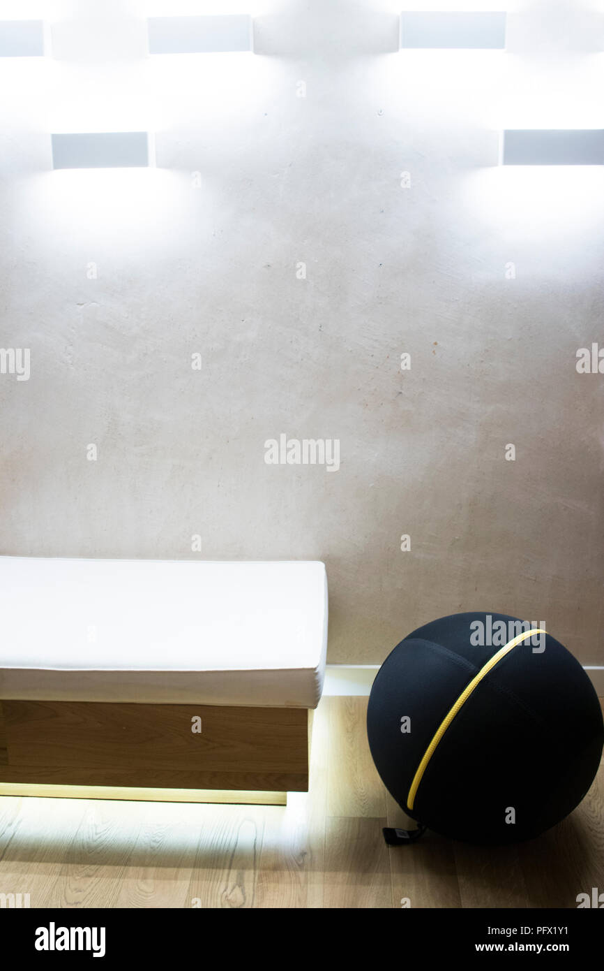 Pilates yoga fitness studio gym room with bench seat waiting and ...