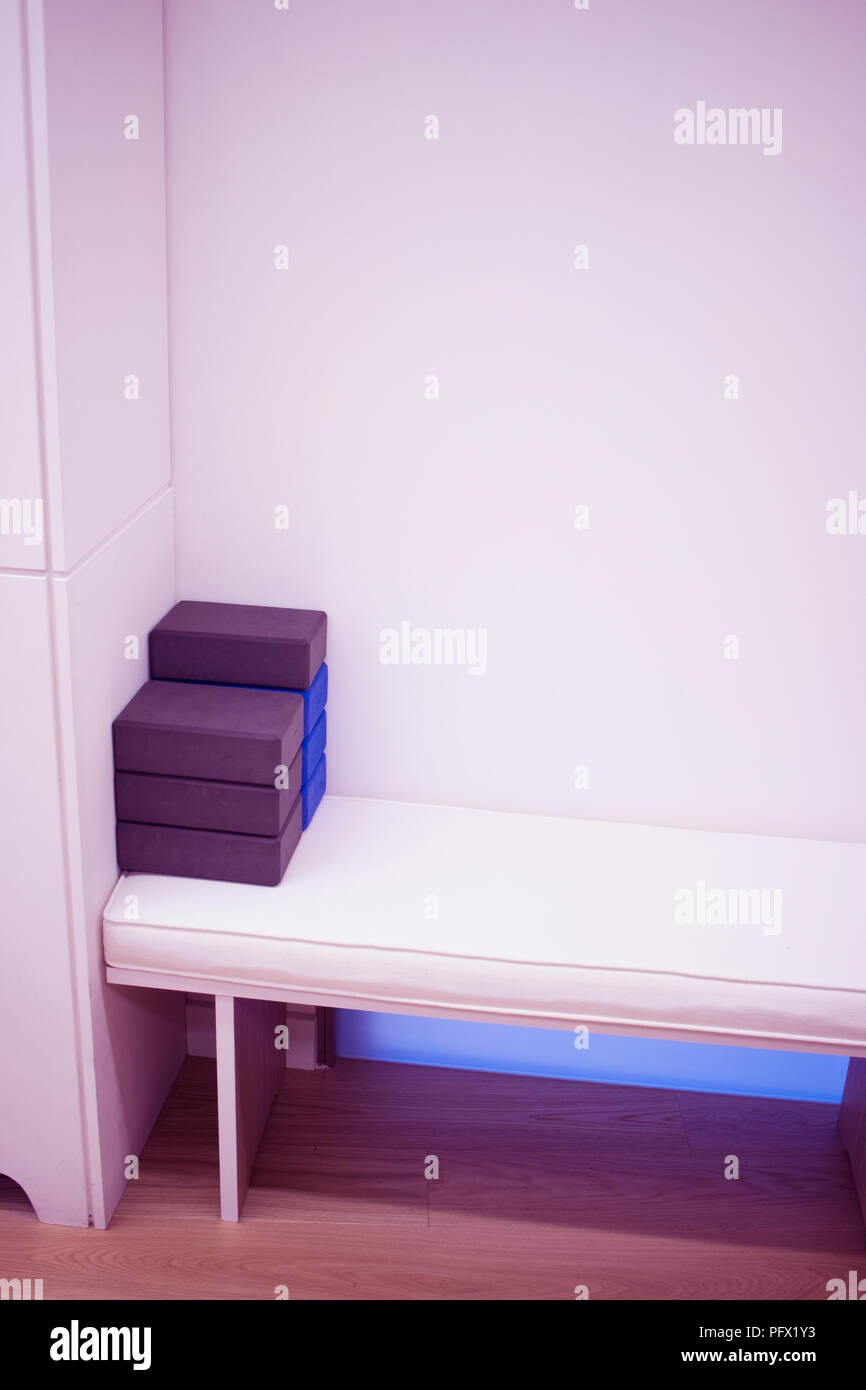 Pilates yoga fitness studio gym room with bench seat waiting and ...