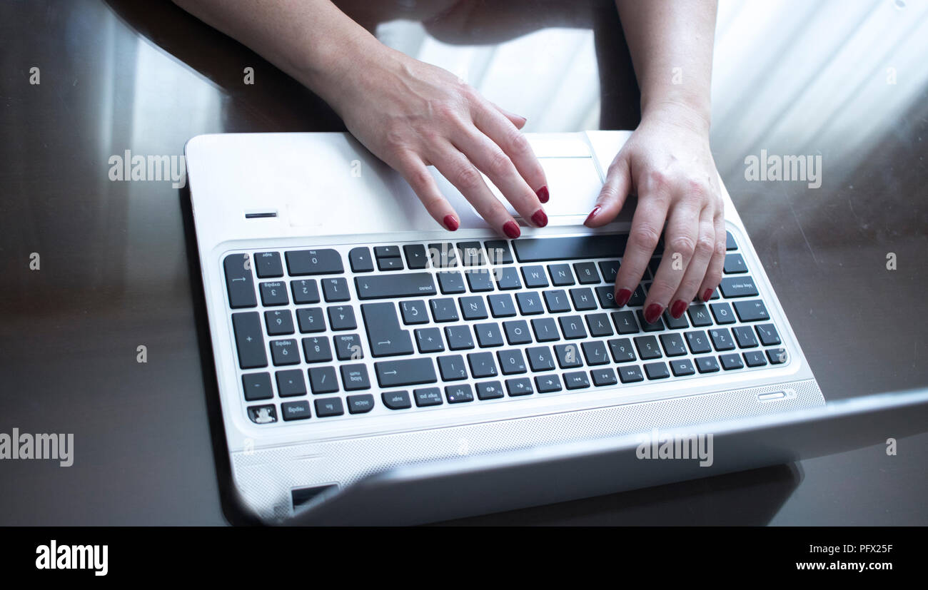 Secretary typist typing on laptop pc computer keyboard keys with hands ...