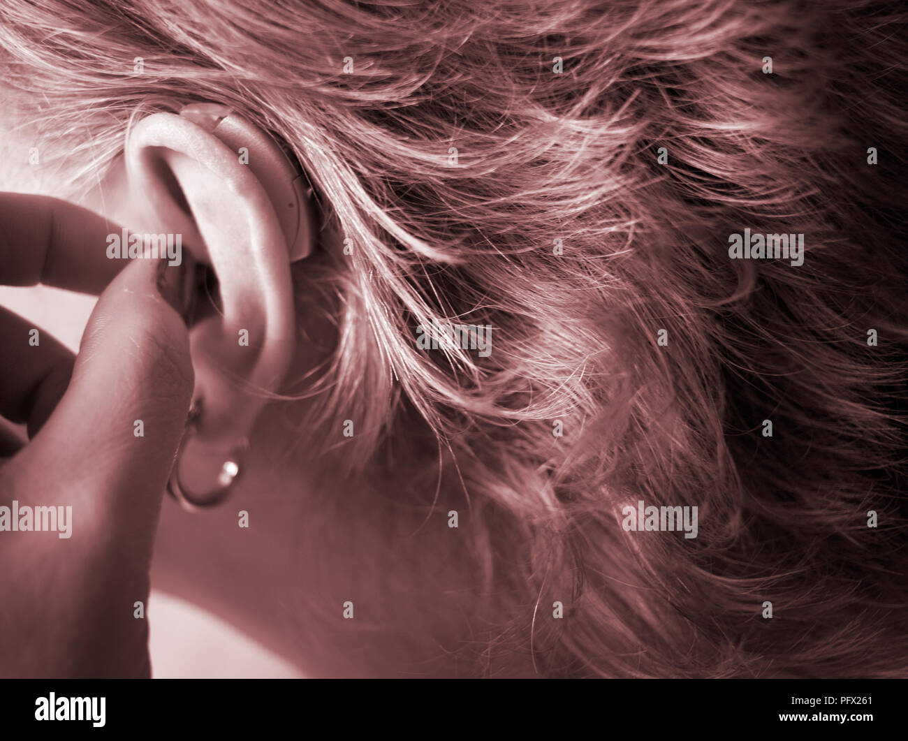 Deaf lady with modern technology digital hearing aid in her ear Stock ...