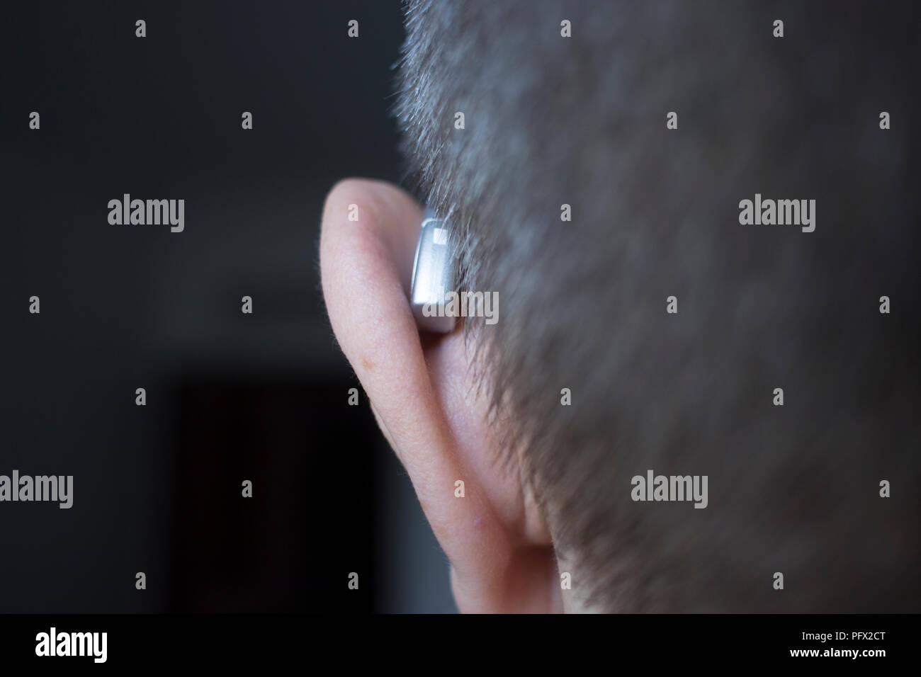 Modern compact in the ear digital audiophone hearing aid in the ear of ...