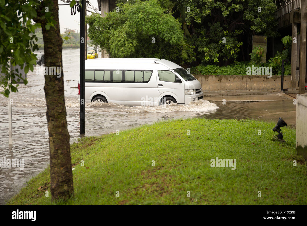 Car driving through flood water on the road Stock Photo - Alamy